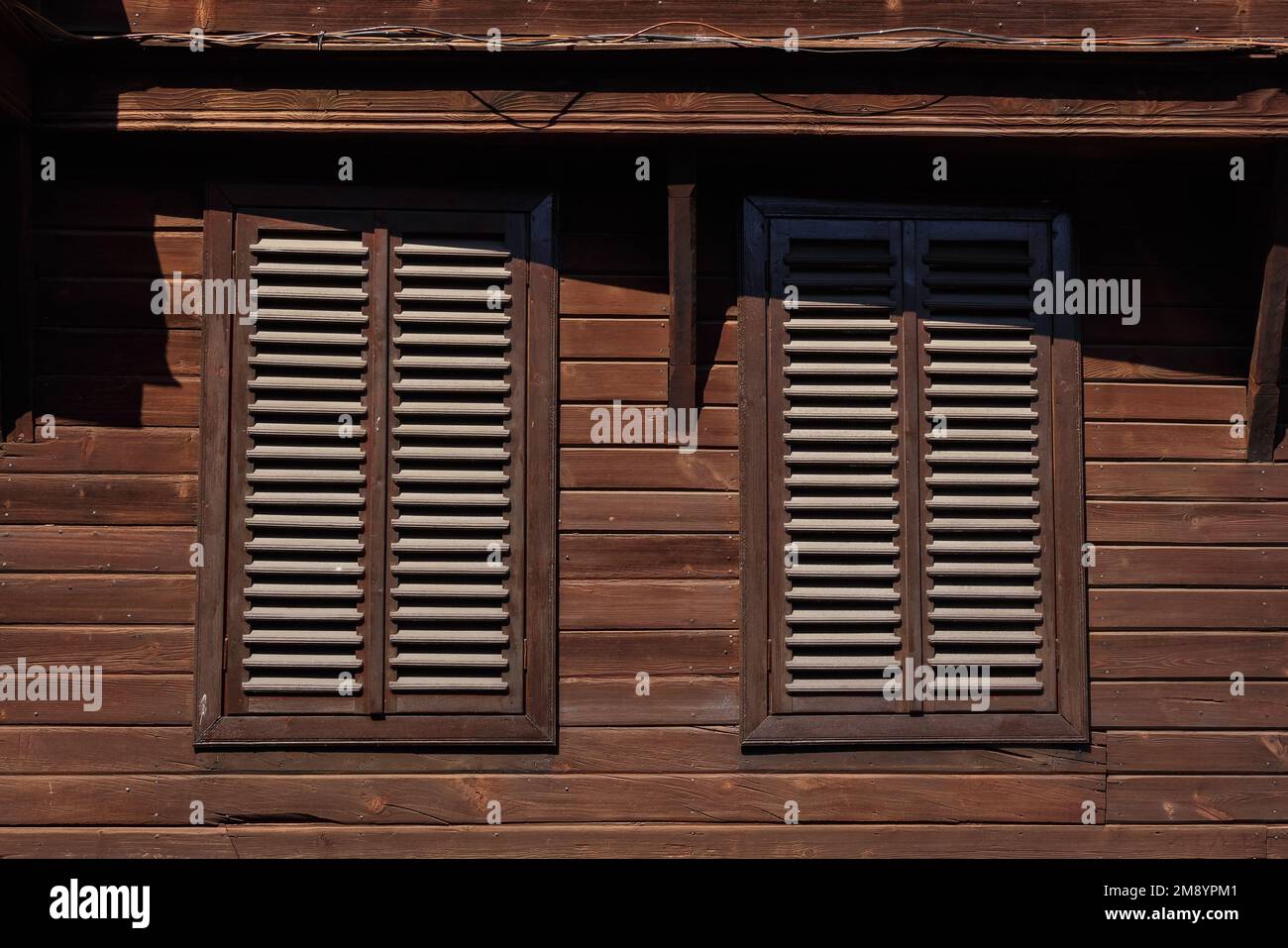 windows on the wooden facade in bulgaria. architectural retro elemet ...