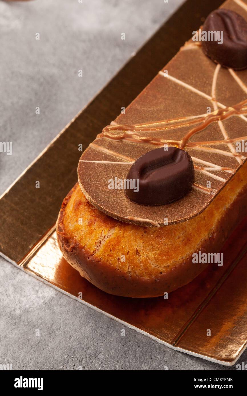 Eclair with custard, chocolate icing and chocolate coffee beans Stock ...