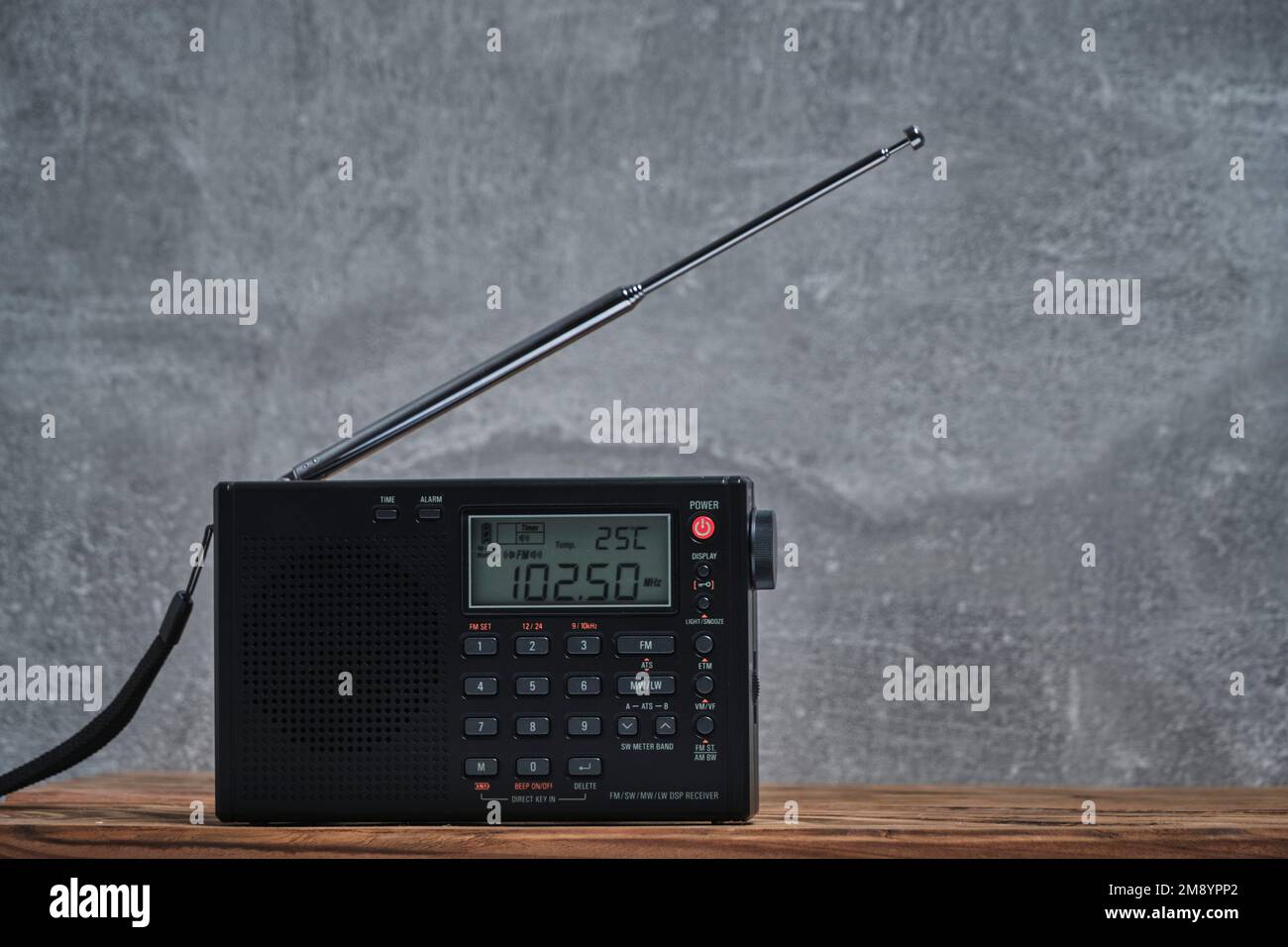 Digital radio receiver with elongated antenna gray concrete background ...