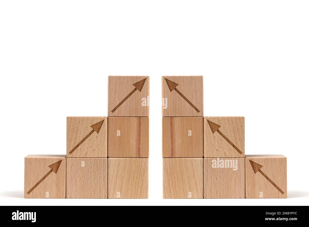 Pyramid of wooden cubes with arrows leading to top white background ...