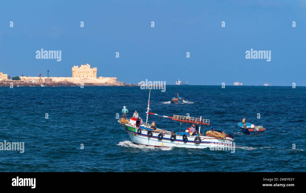 An aerial view of boats on sea in background of buildings in Alexandria ...