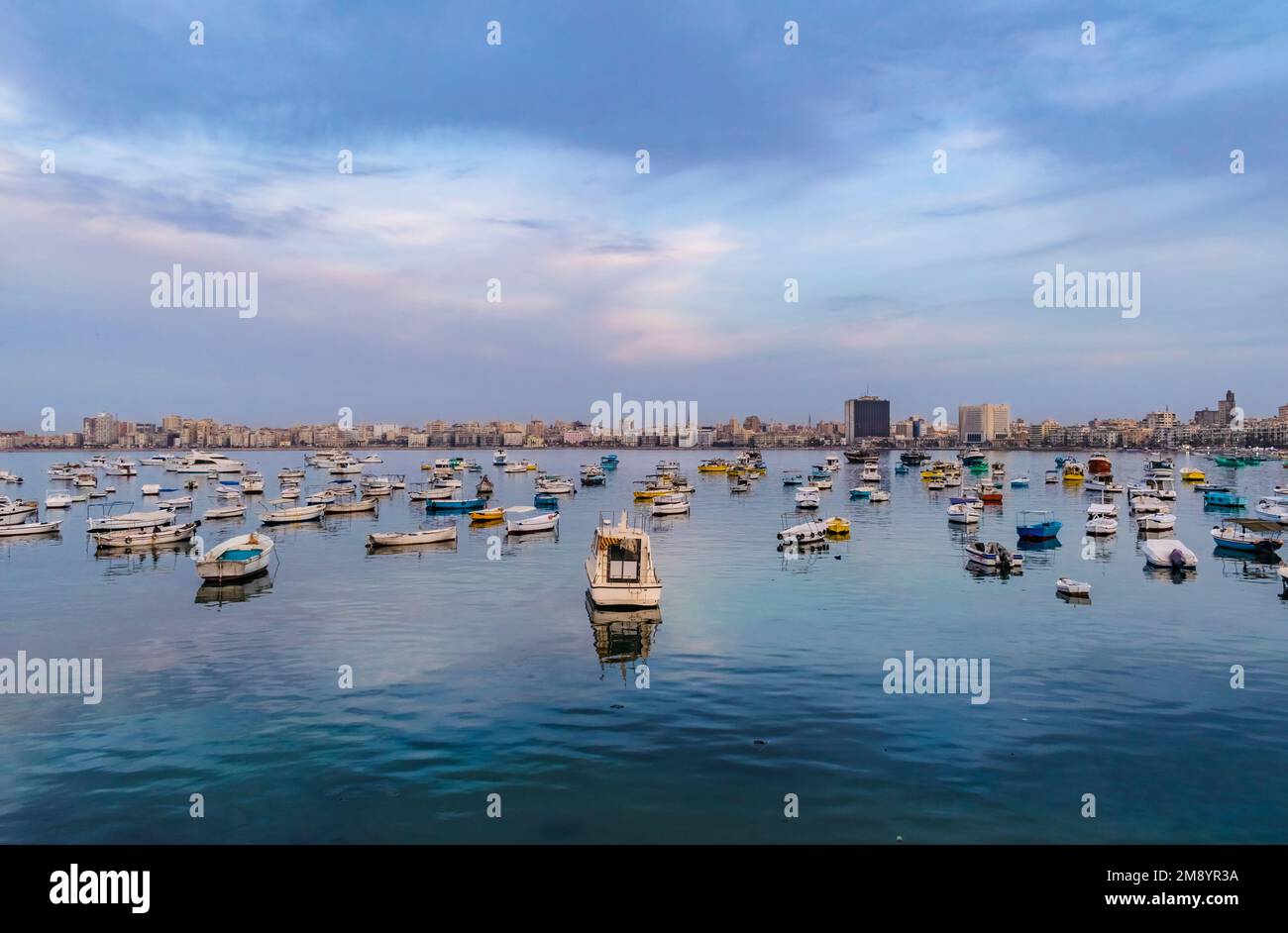 An aerial view of boats on sea in background of buildings in Alexandria ...