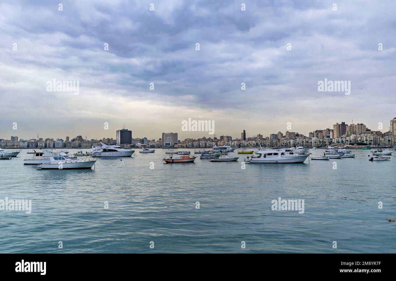 An aerial view of boats on sea in background of buildings in Alexandria ...
