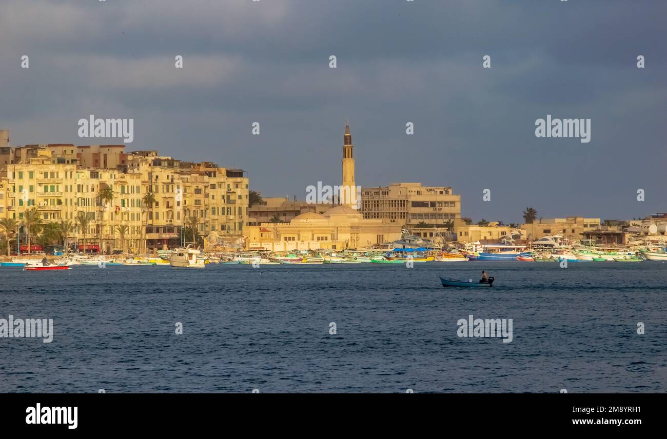 An aerial view of boats on sea in background of buildings in Alexandria ...