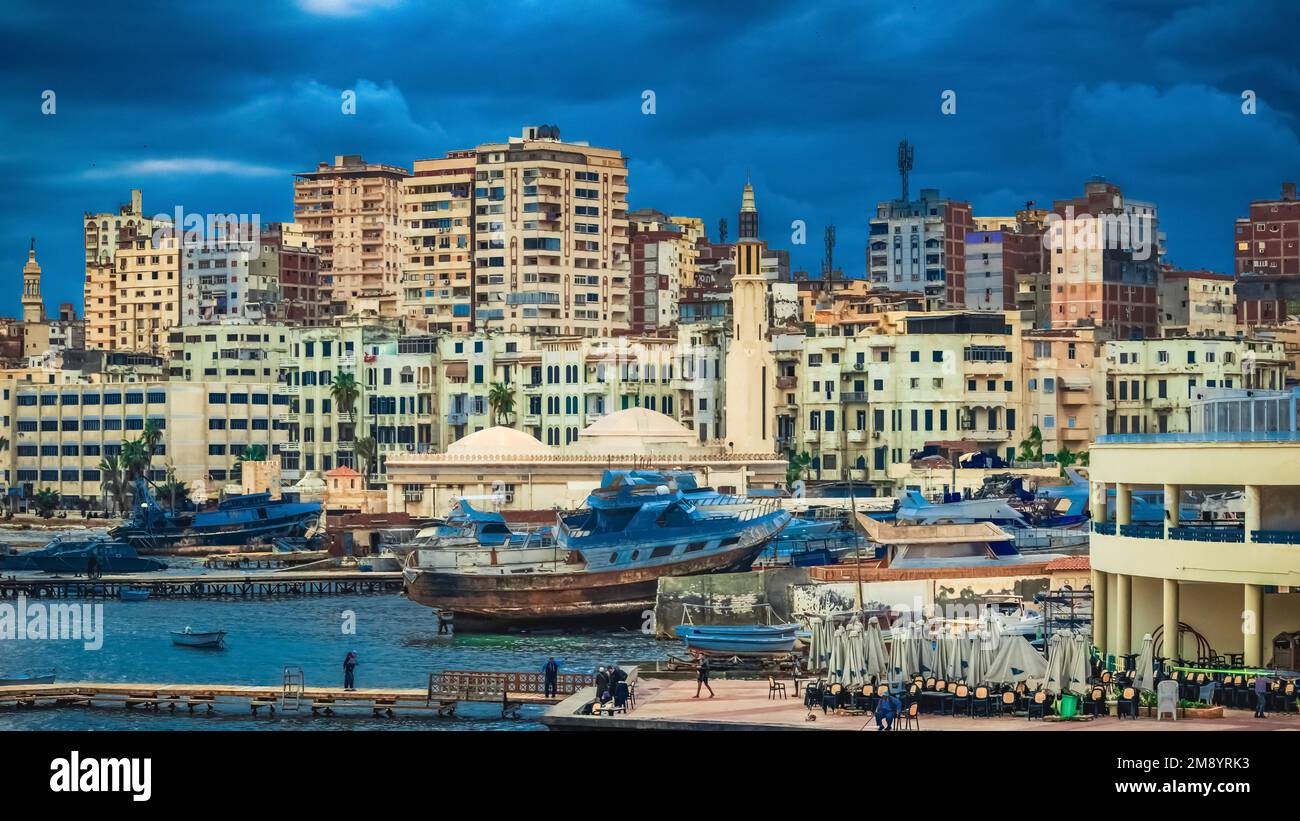 An aerial view of boats on sea in background of buildings in Alexandria ...