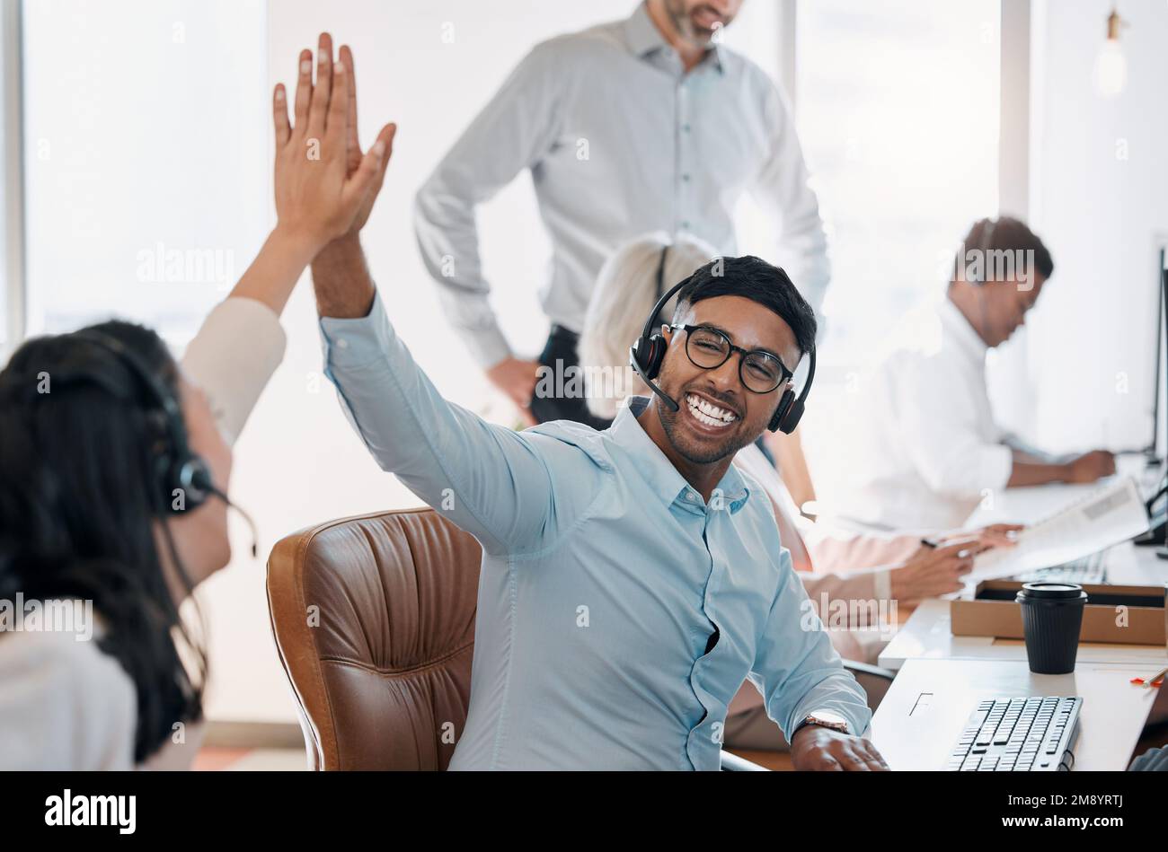 Lets go team. a handsome young agent sitting and giving his colleague a ...