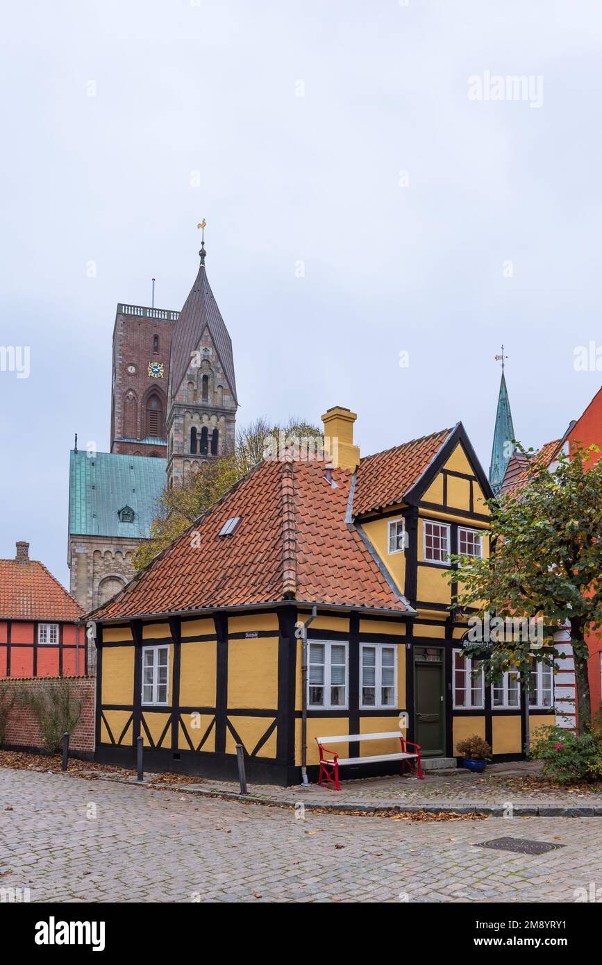 Cityscape with half-timbered house and cathedral in picturesque village ...