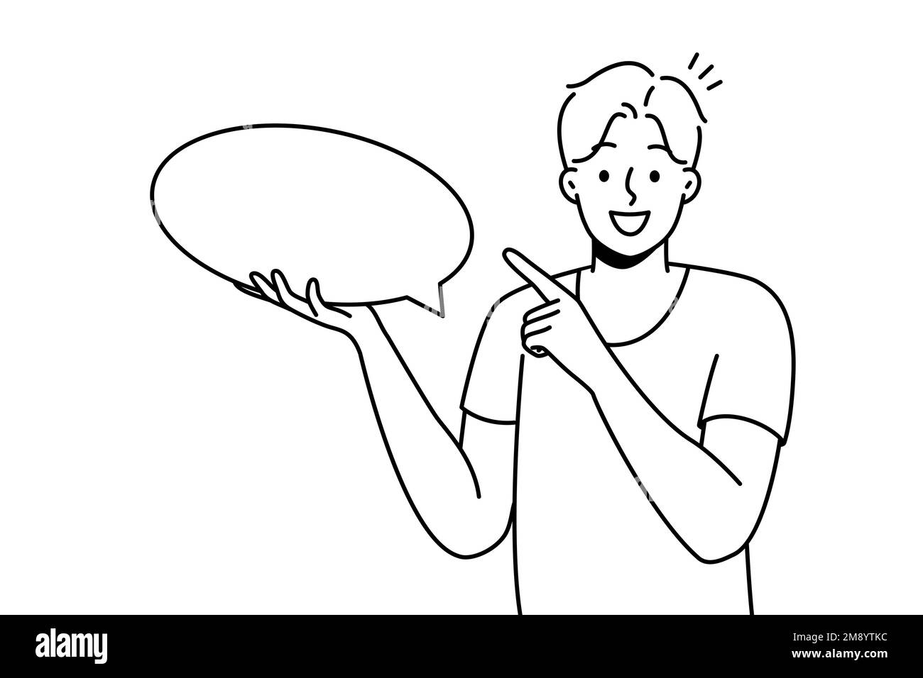Smiling young man holding speech bubble in hands. Happy guy point at mockup empty blank copy ...