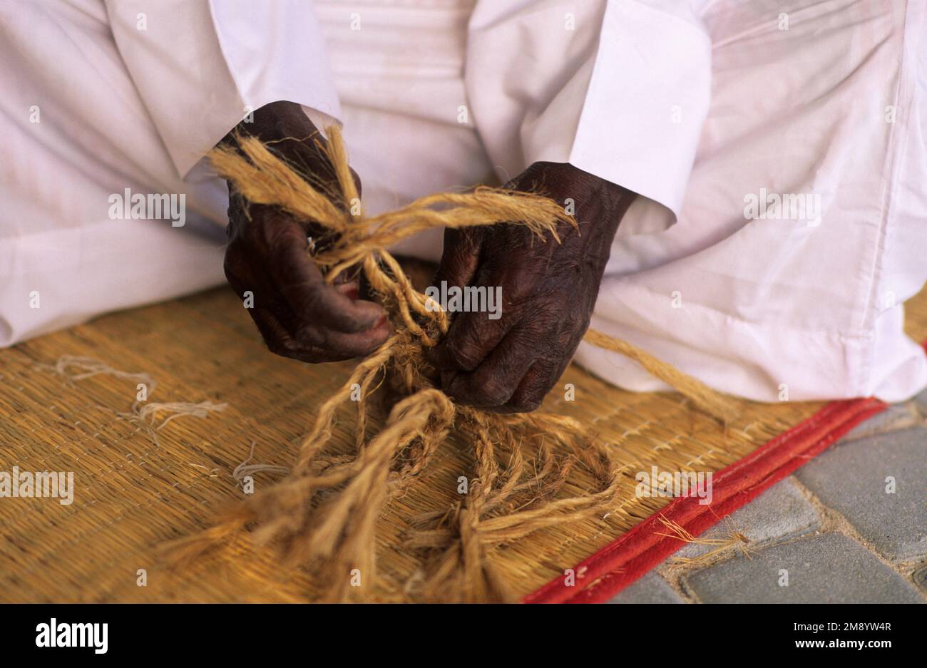 Bahrain, man making fishing rope/nets in the traditional way Stock ...