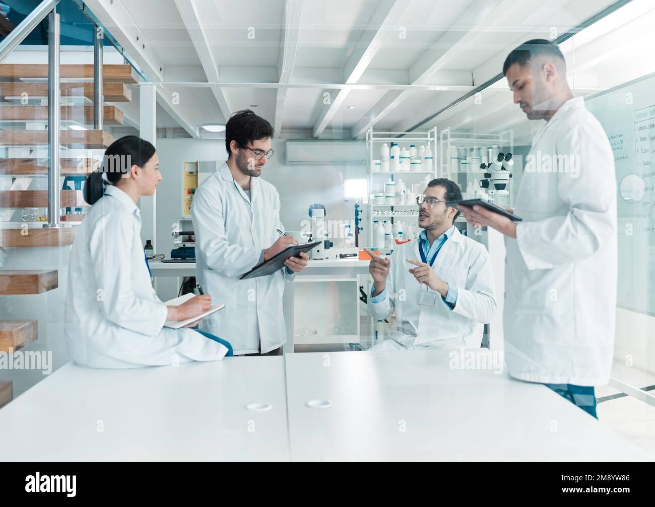 There is a deep investigative nature to science. a group of scientists working together in a lab ...