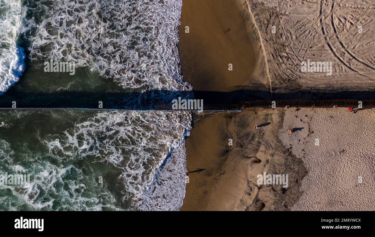 An aerial shot of border wall between the United States and Mexico ...