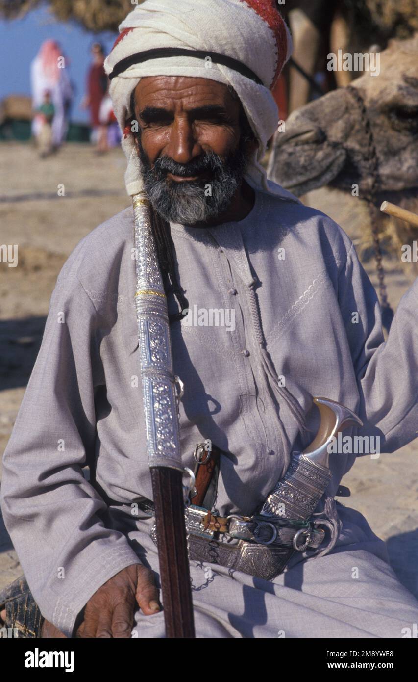 Bahrain, Arab camel owner with traditional staff Stock Photo - Alamy