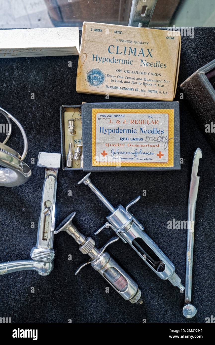 A collection of antique syringes on a black background in California ...