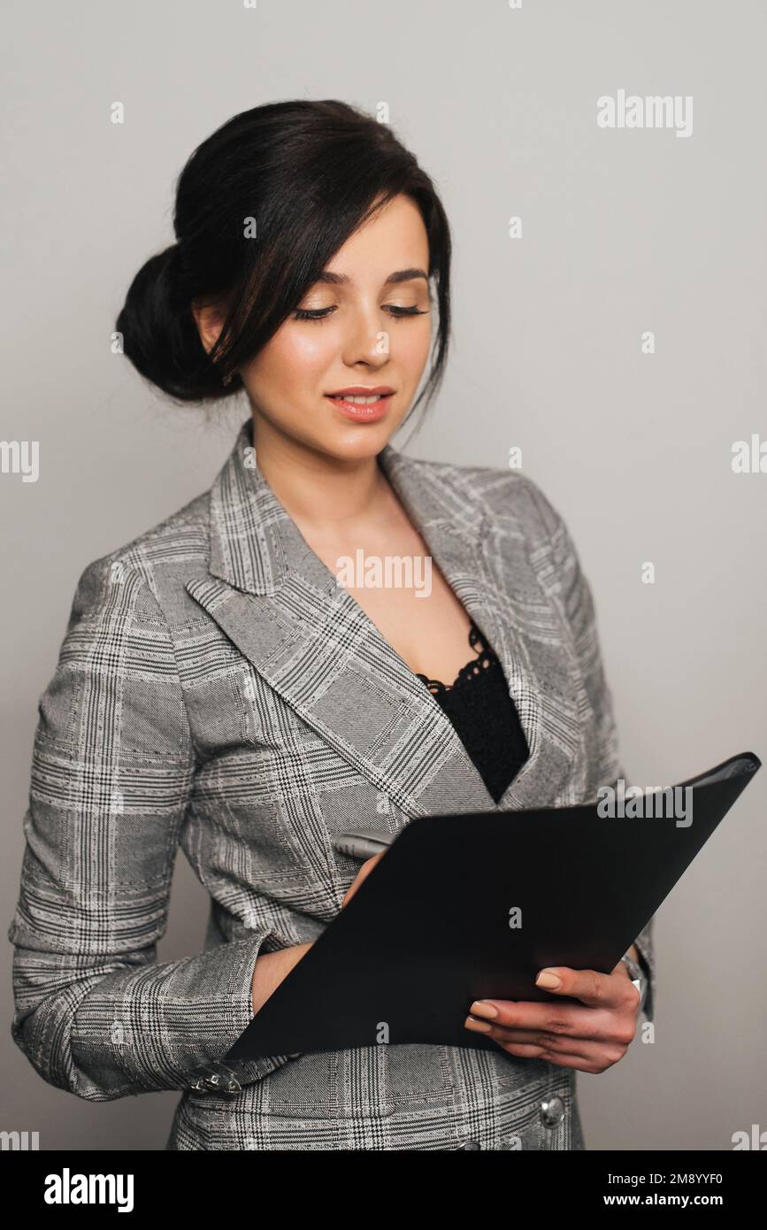 young Secretary girl in business suit with documents and beautiful ...
