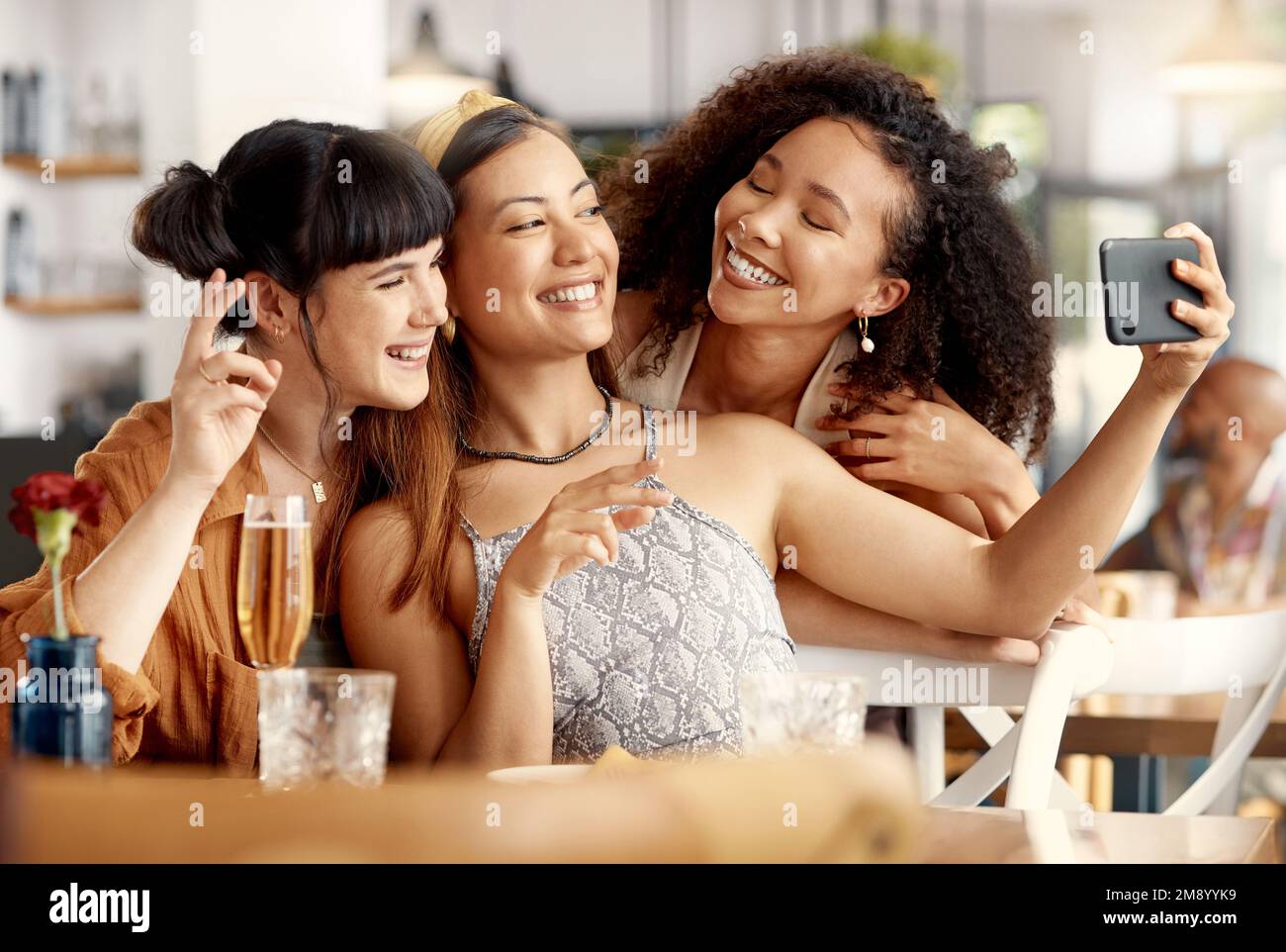 Best friends coming together. a group of young friends taking selfies ...