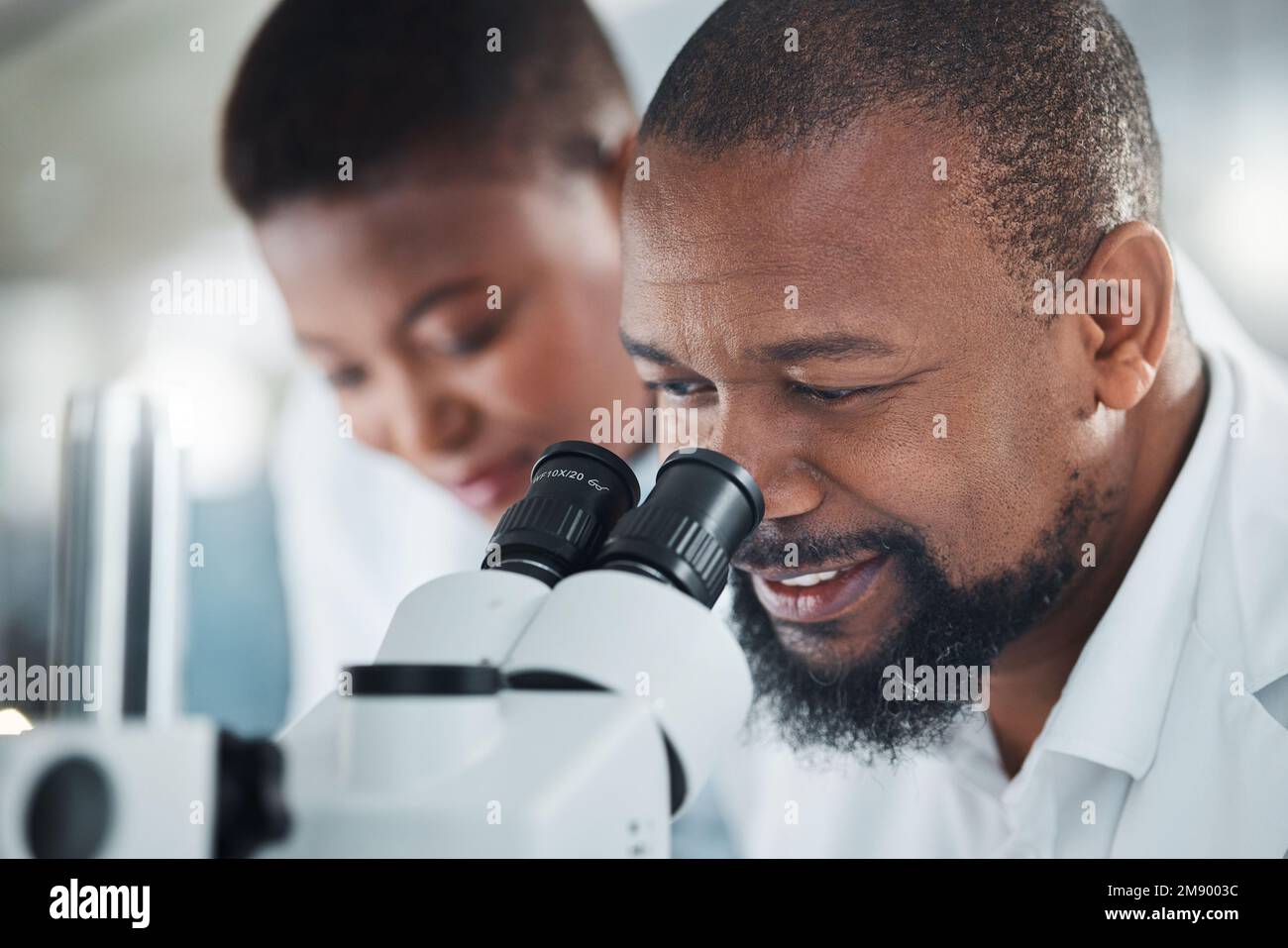Problem solving is what they do best. a mature man using a microscope ...