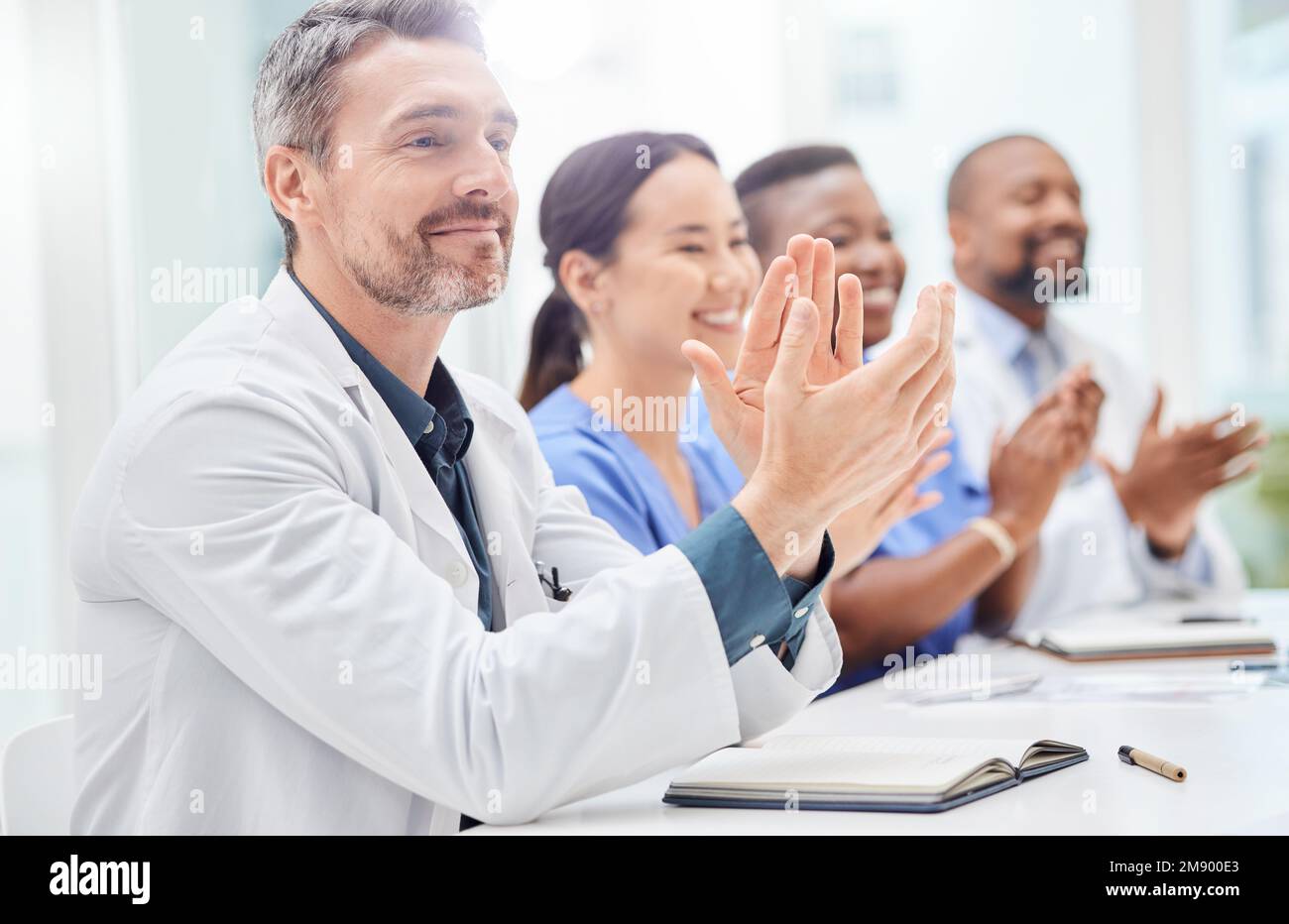 Showcasing effective multidisciplinary collaboration. a doctor sitting ...