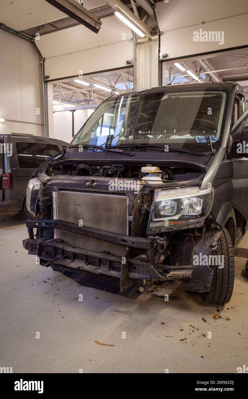 in the car repair shop there is a van whose front was severely damaged ...