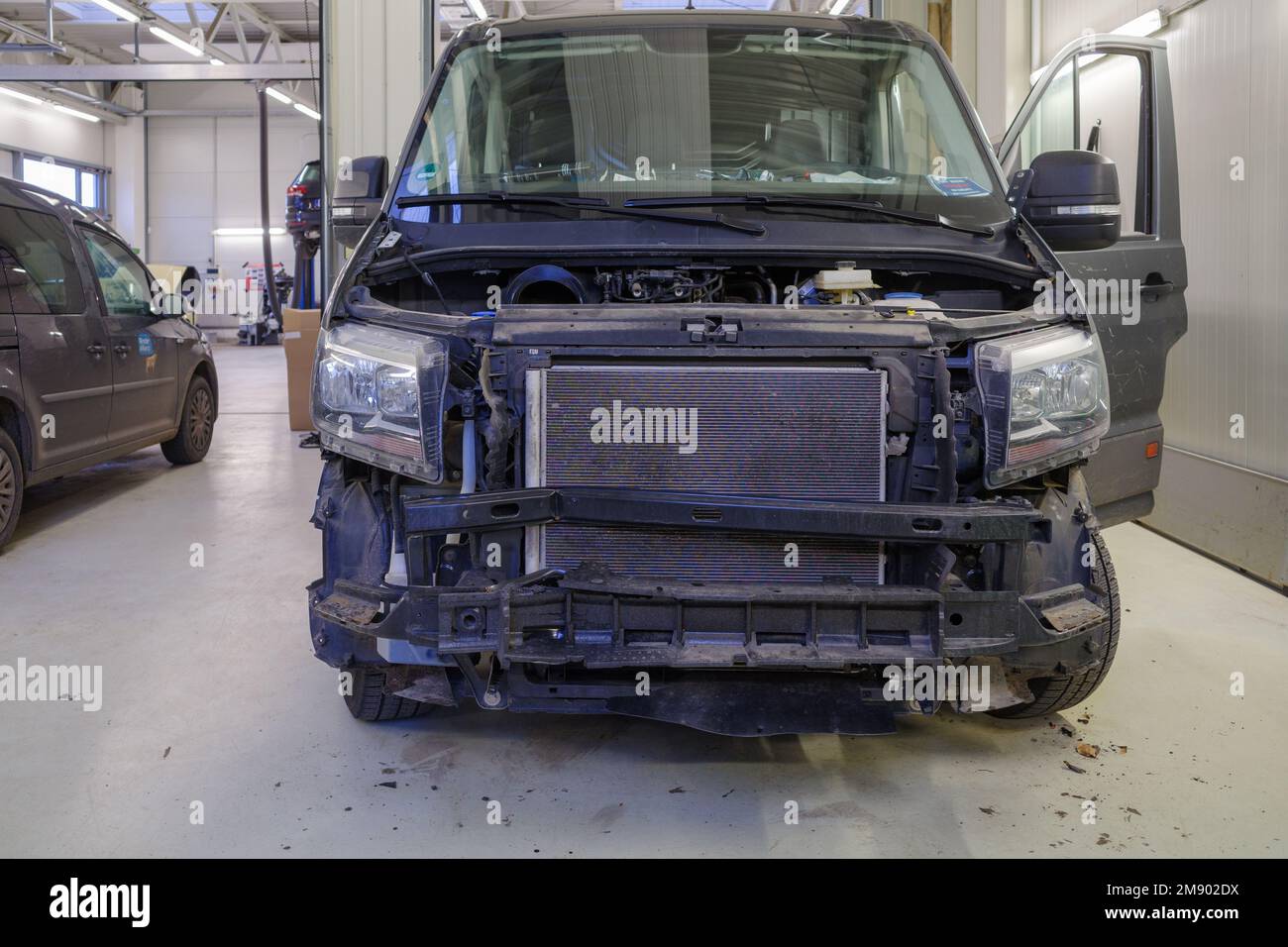 in the car repair shop there is a van whose front was severely damaged ...