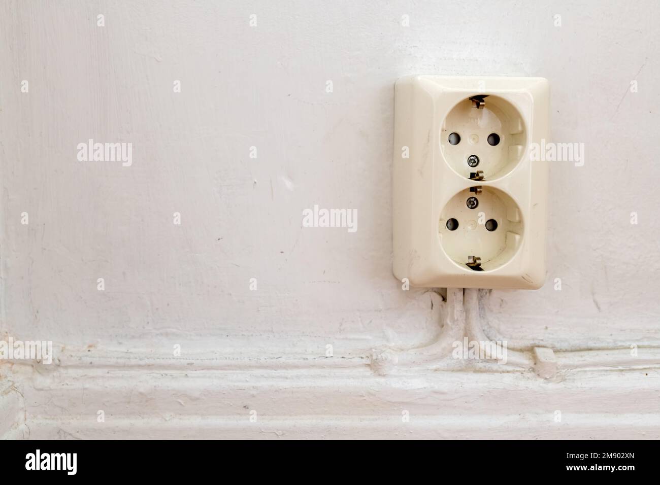 Old european electricity socket with cables on the wall, selective ...