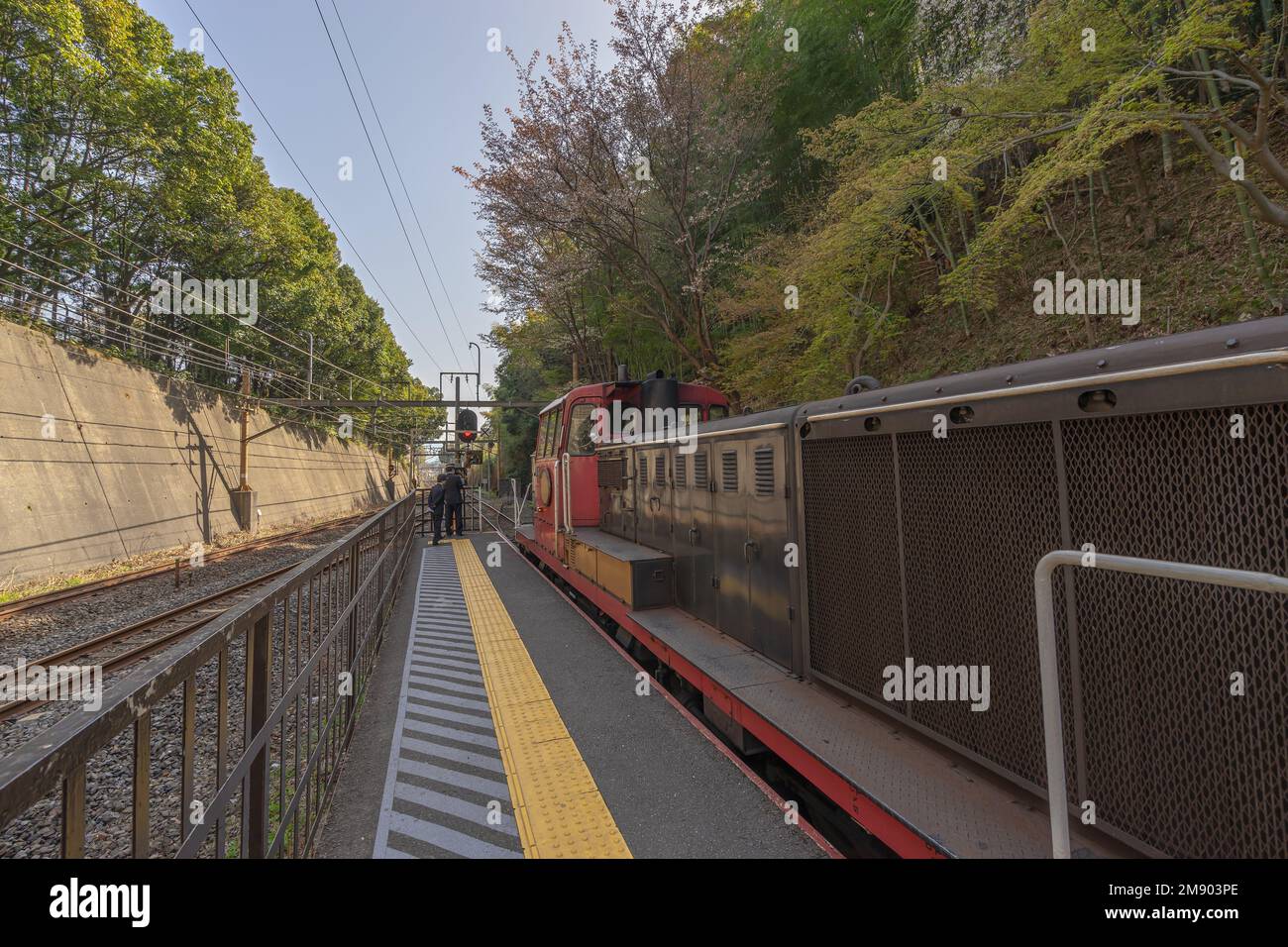 Scenic of the Red train park in the station with the Station Master ...