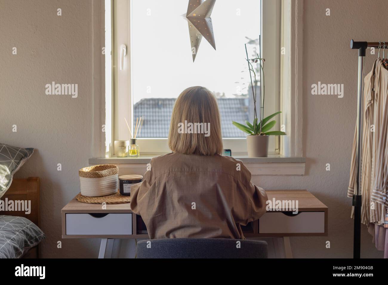 Home office by window. Freelancer woman works Stock Photo - Alamy