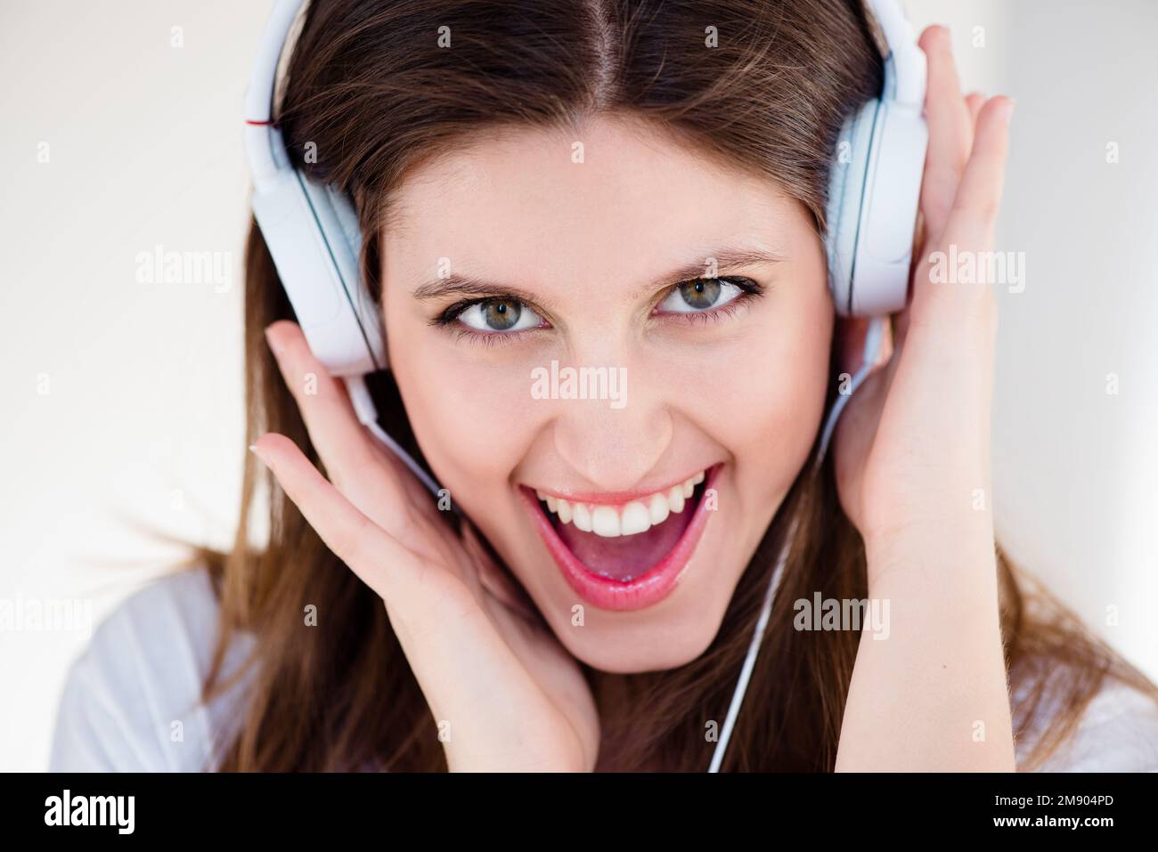 Live out loud. a young woman listening to music against a studio ...