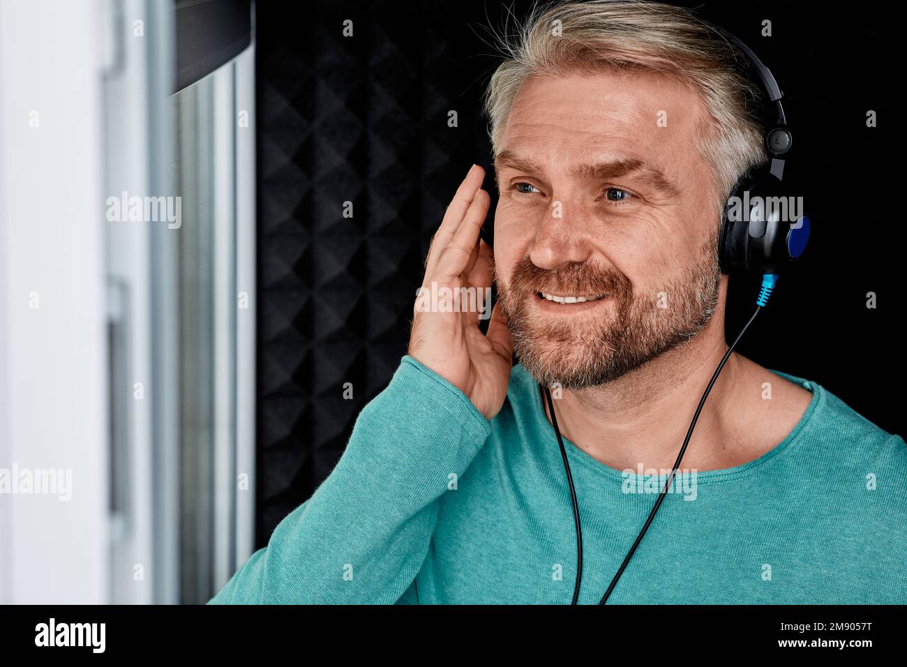 Adult man wearing audiometry headphones while hearing test and ...