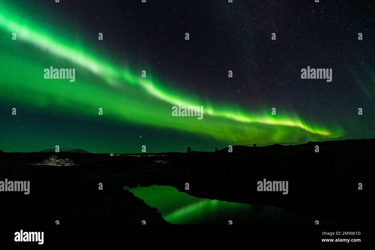 Green light rays over the canal at night Stock Photo - Alamy