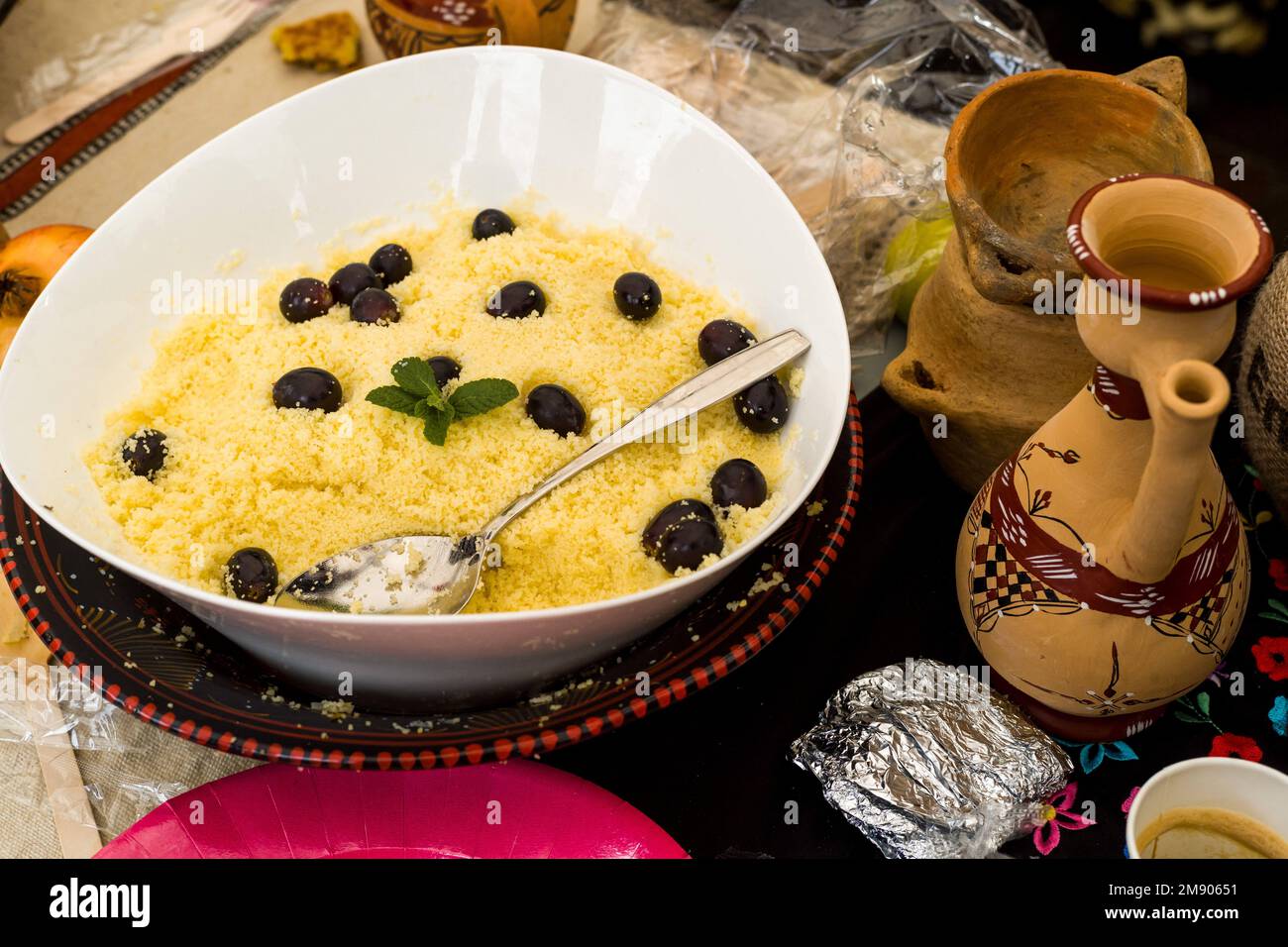 A dish with semolina and olives.Celebration of YENNAYER 2973 (Berber ...