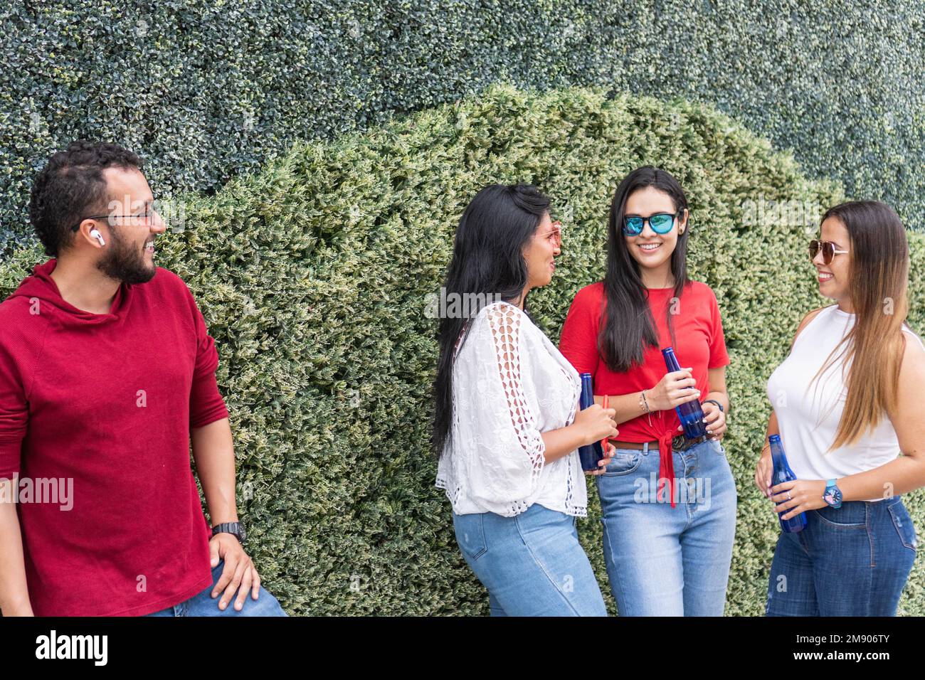 Latino man near multiethnic friends talking in the street Stock Photo ...