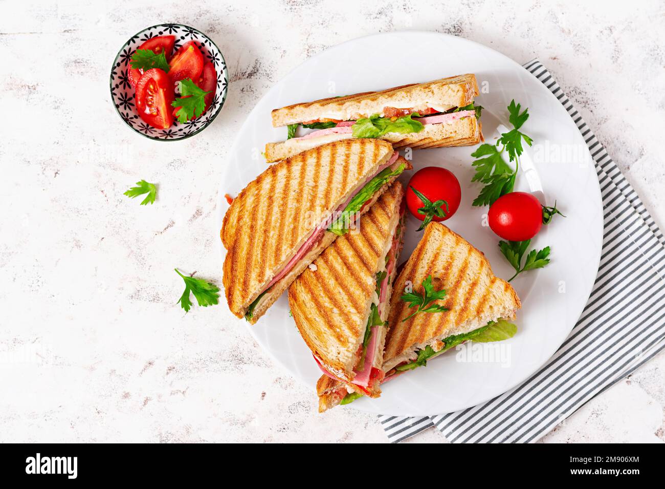Club sandwich panini with ham, tomato, cheese and lettuce. Top view ...