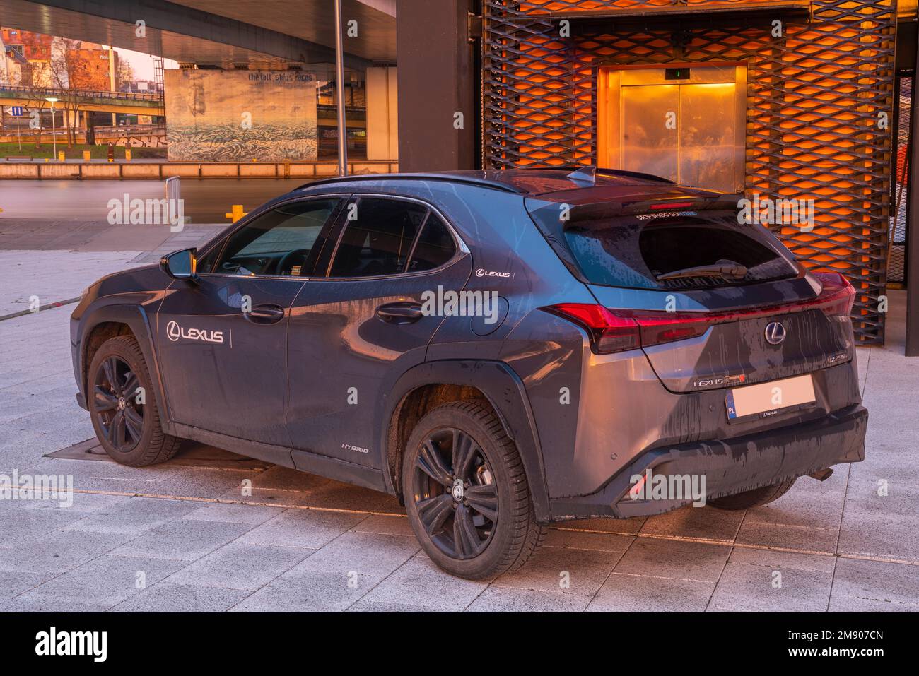 Lexus UX hybrid SUV against the background of a modern building in the ...