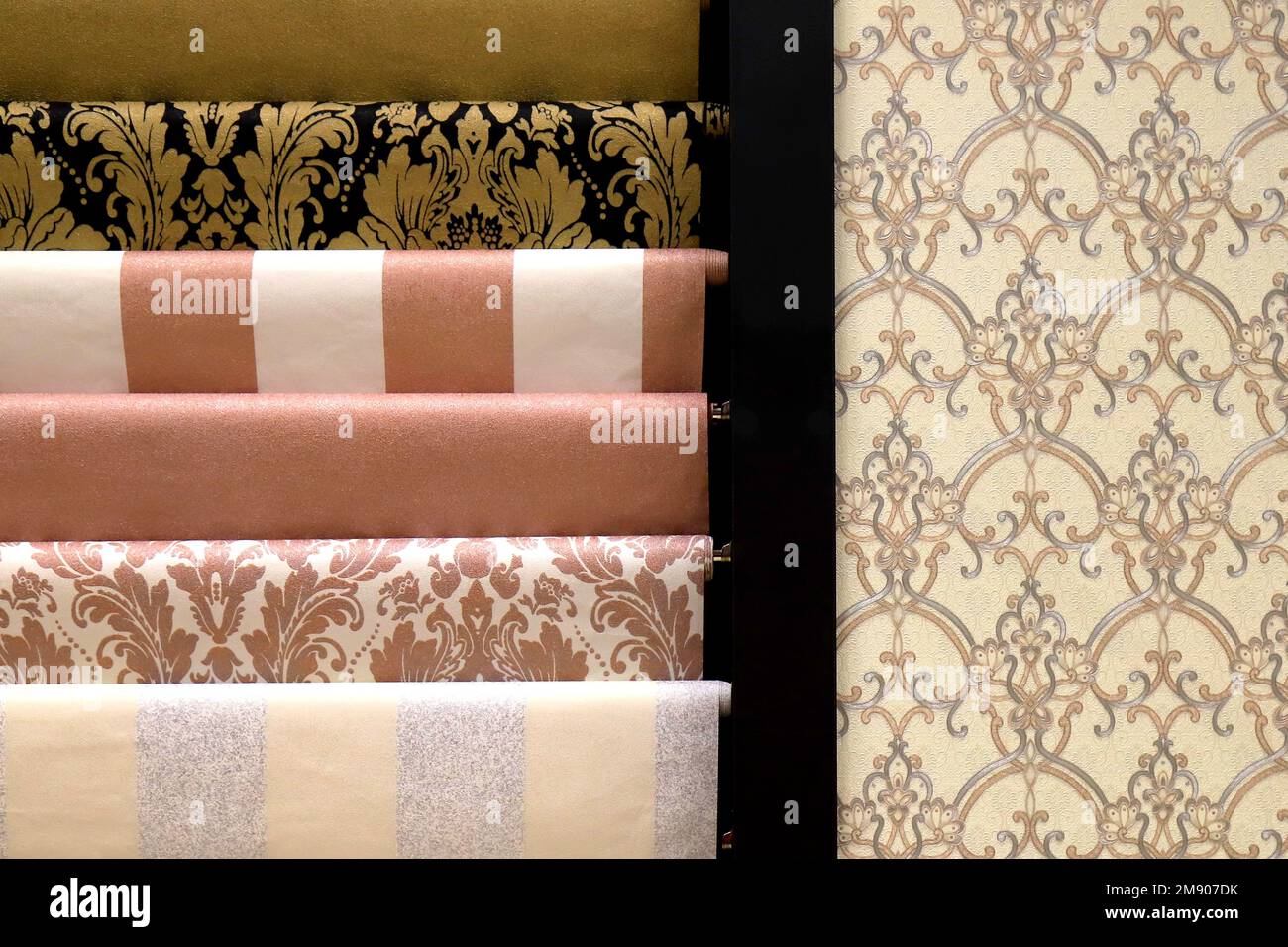 Rolls of vinyl wallpaper in building materials store. Wallpaper with ...