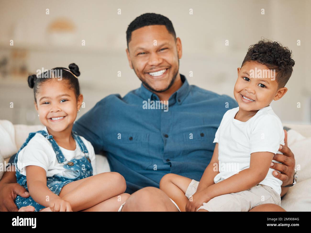 Everything else comes second. a young father sitting on the sofa at ...