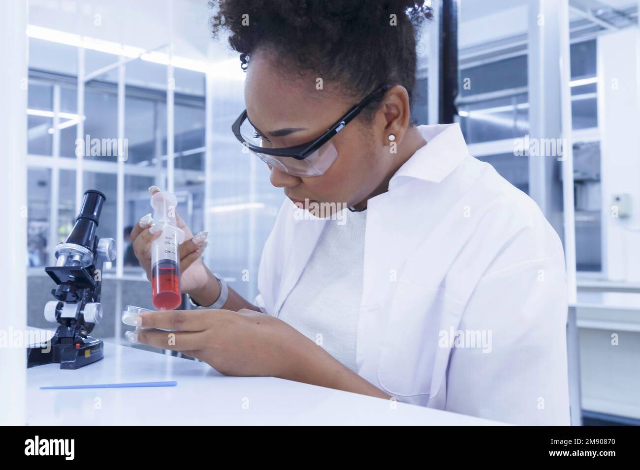 black female doctor student examining and analysis virus test sample on ...