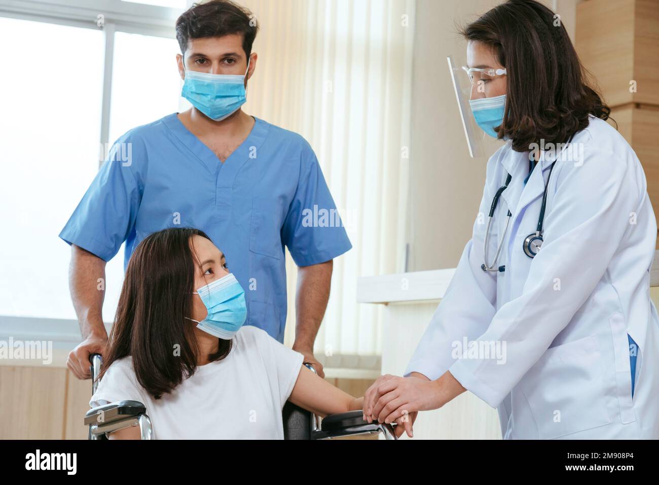 asian female doctor with male nurse wearing protective face mask ...