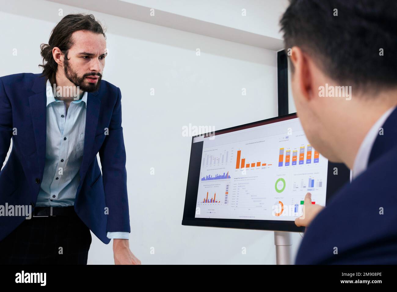 Two young investor businessmen meeting to analysis risk and profit ...