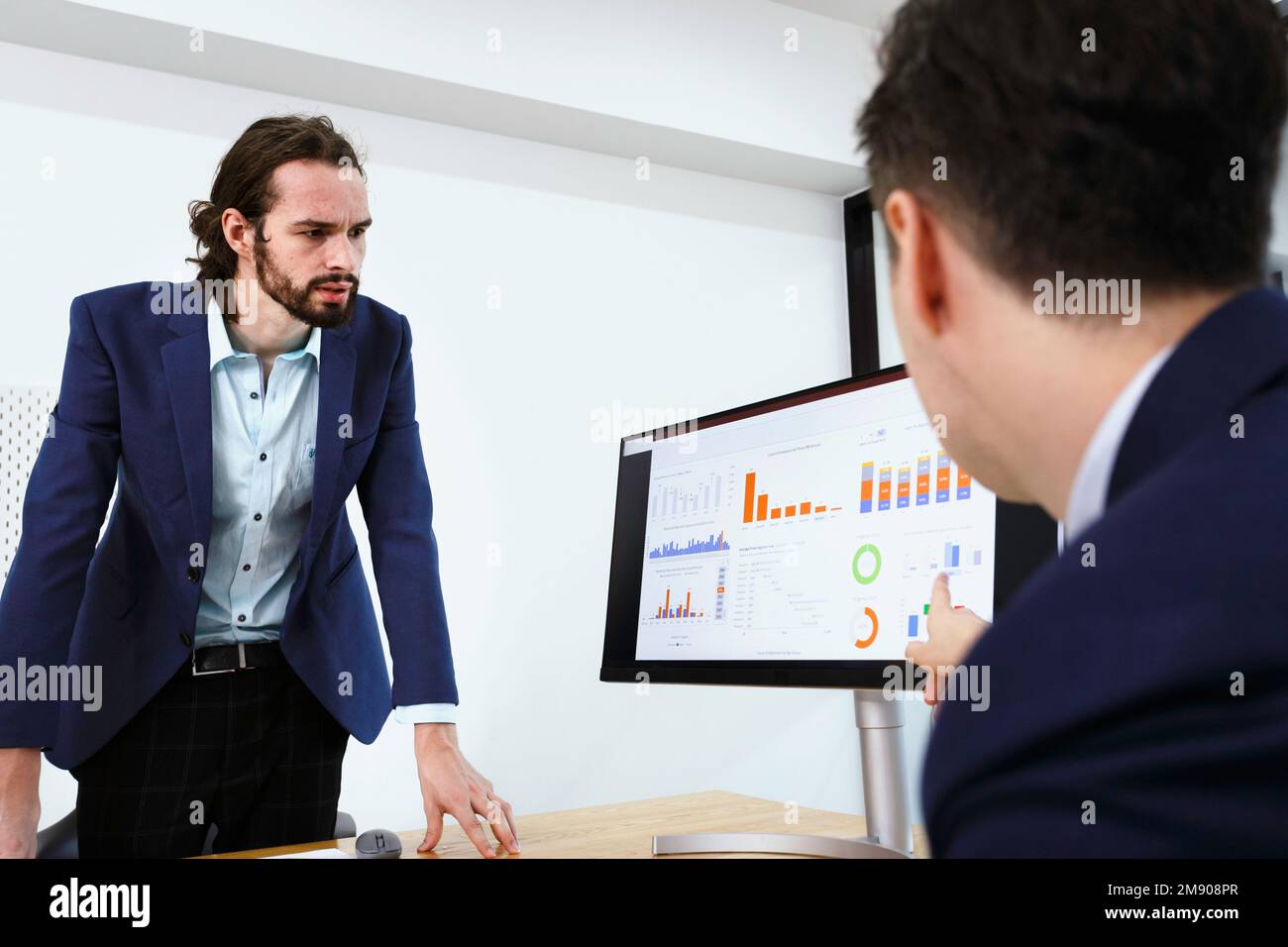 Two young investor businessmen meeting to analysis risk and profit ...