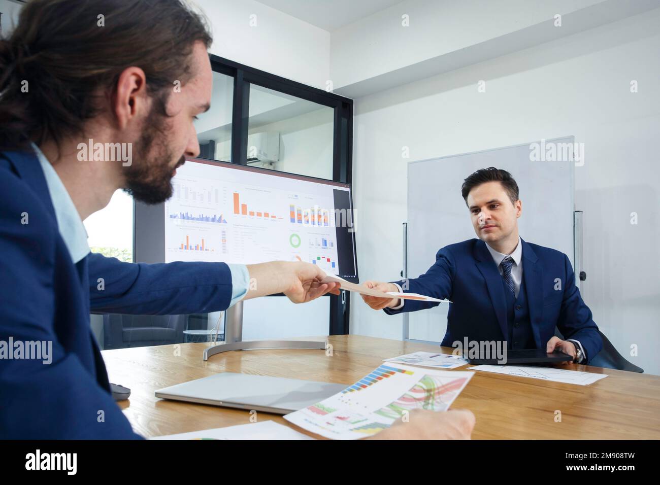 Two young investor businessmen meeting to analysis risk and profit ...