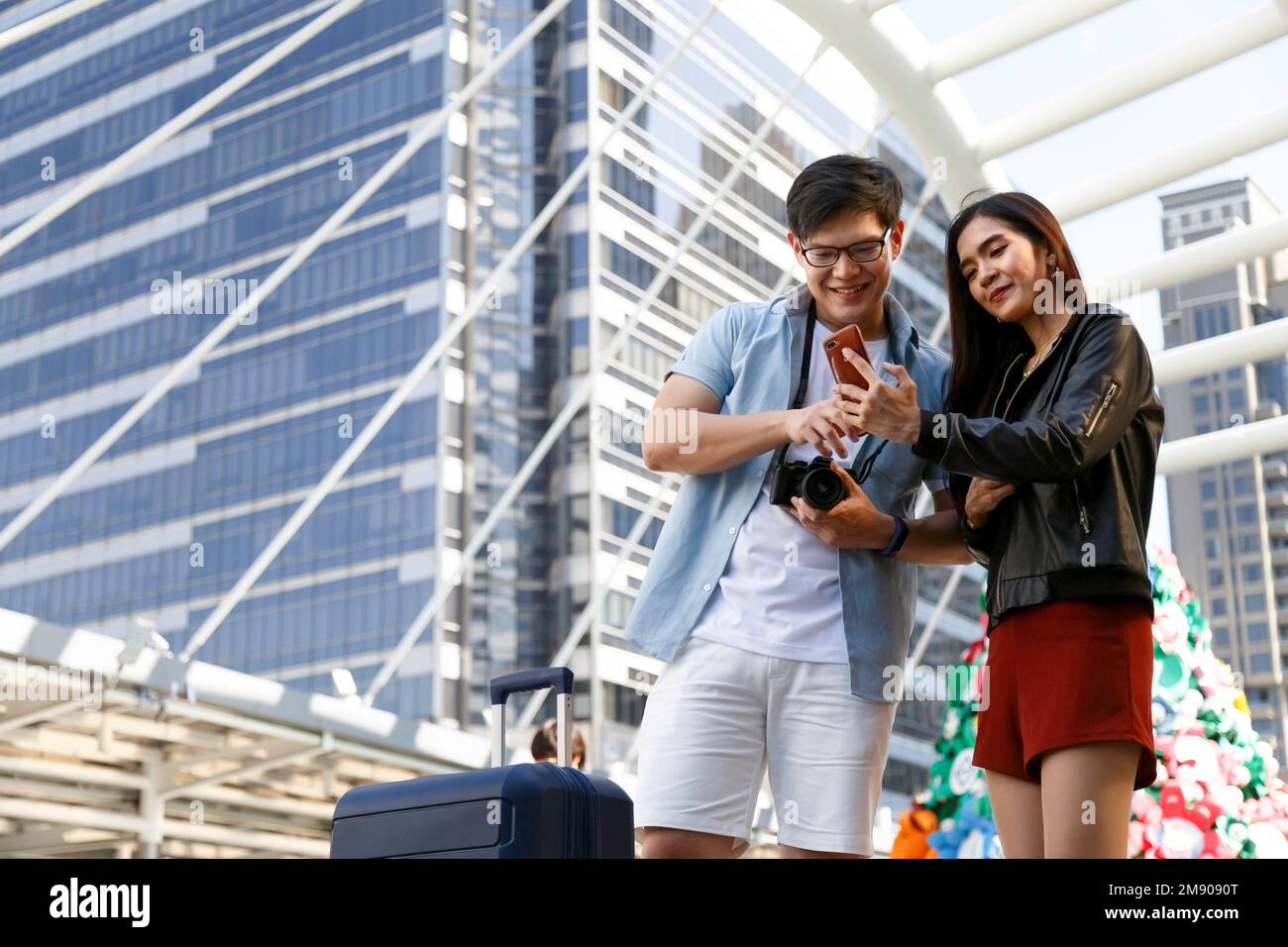 asia city travel. smiling happy young asian couple looking at ...