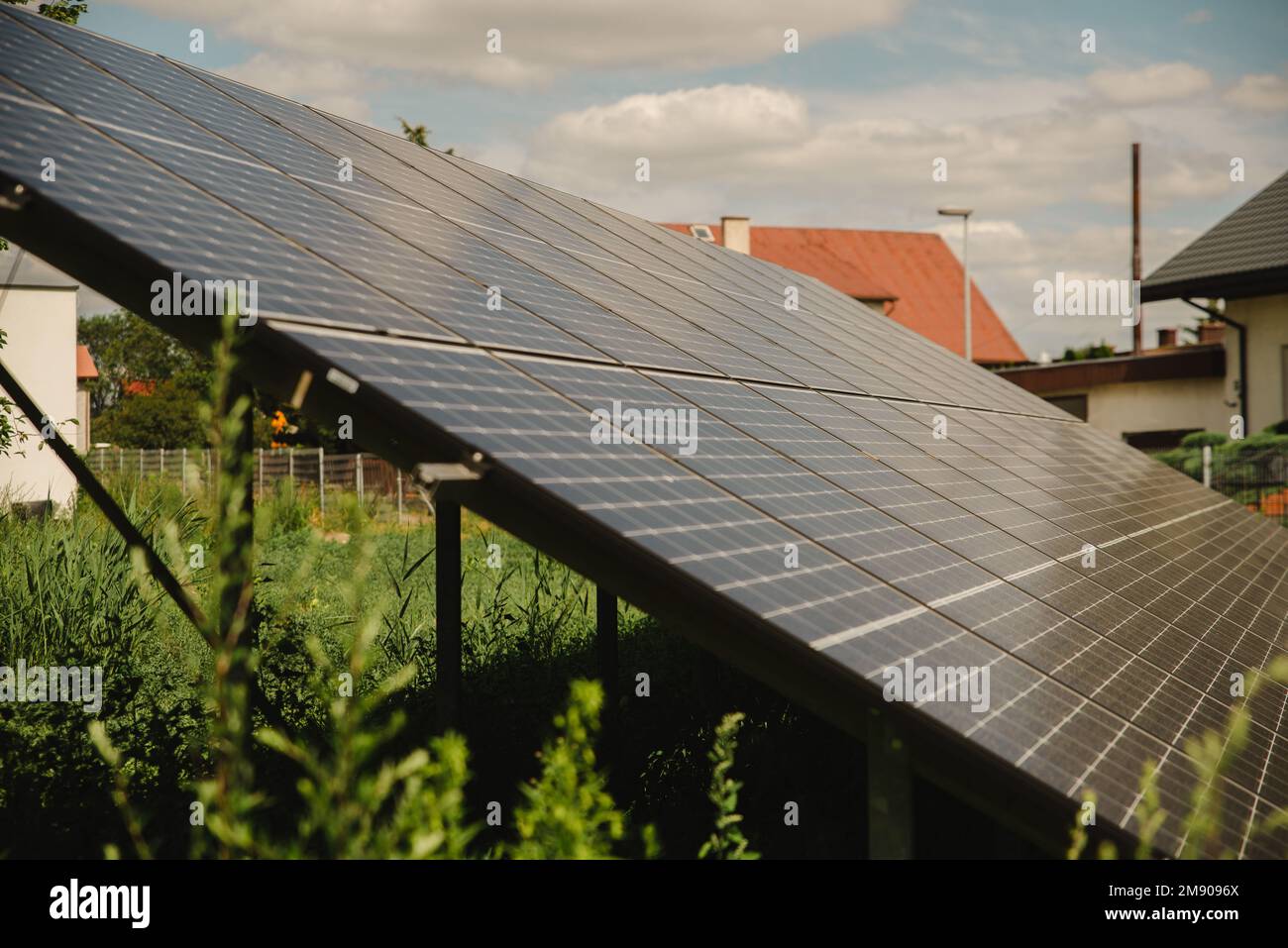 solar panels in front yard, free energy factory, offgid Stock Photo - Alamy