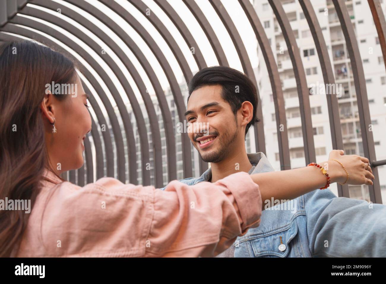 Asian happy smiling woman and man running open arms to embrace to ...
