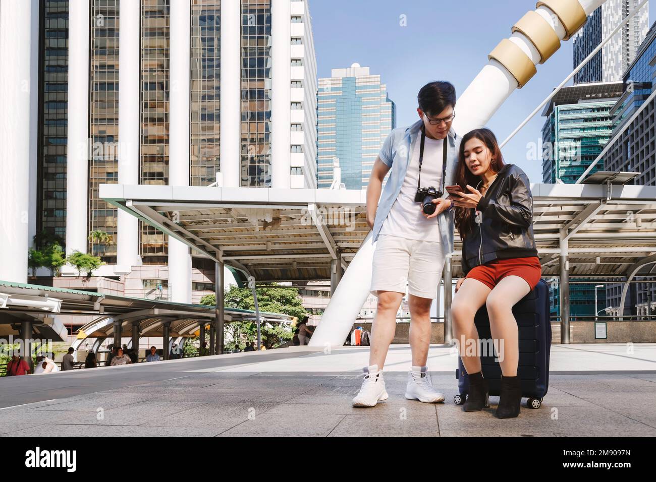 asia city travel. smiling happy young asian couple looking at ...