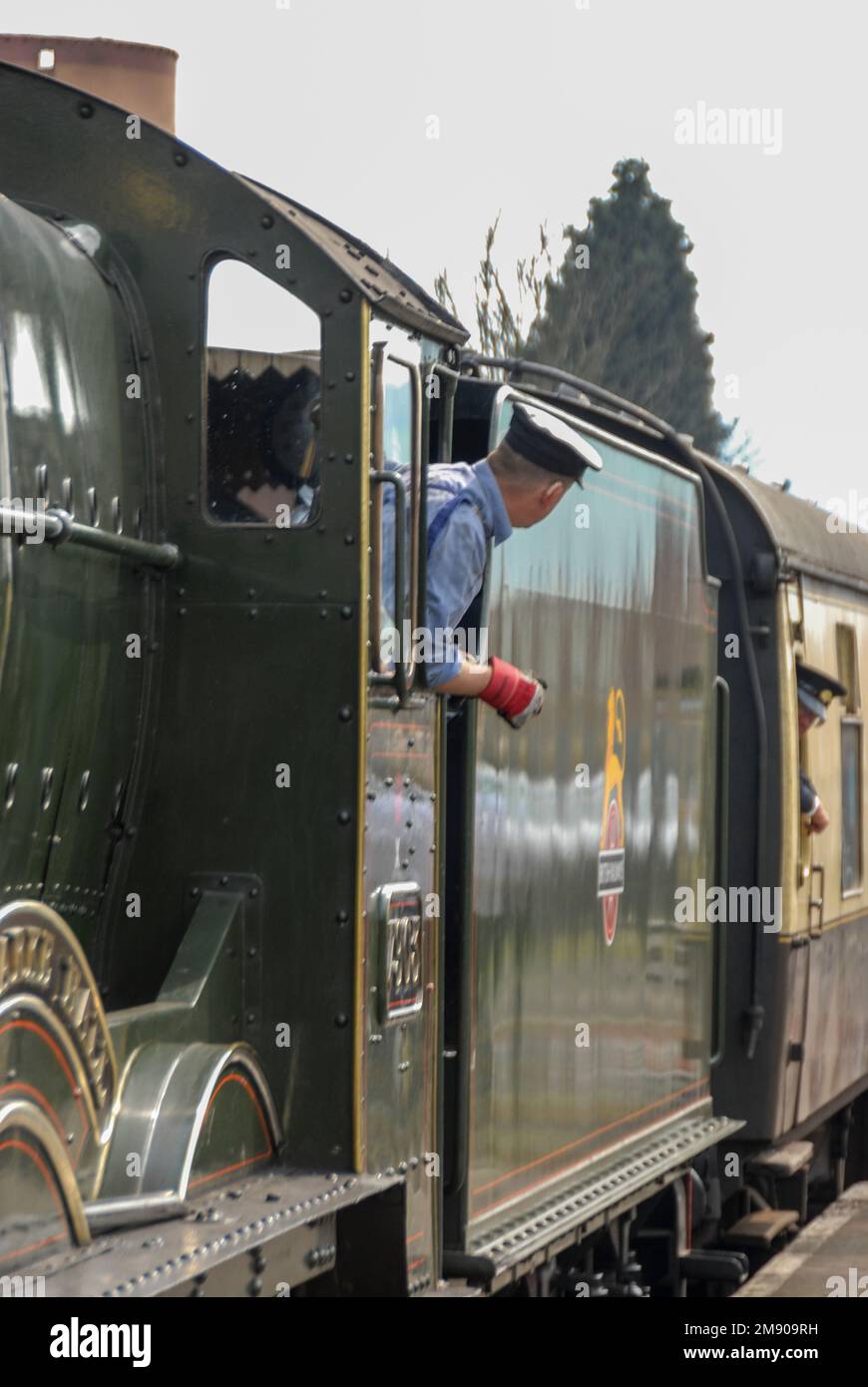The train driver leans out of his cab on the 1949-built steam train ...