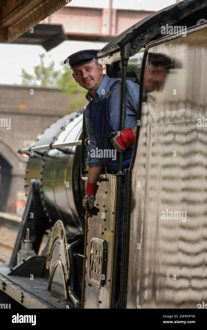 The train driver leans out of his cab on the 1949-built steam train ...