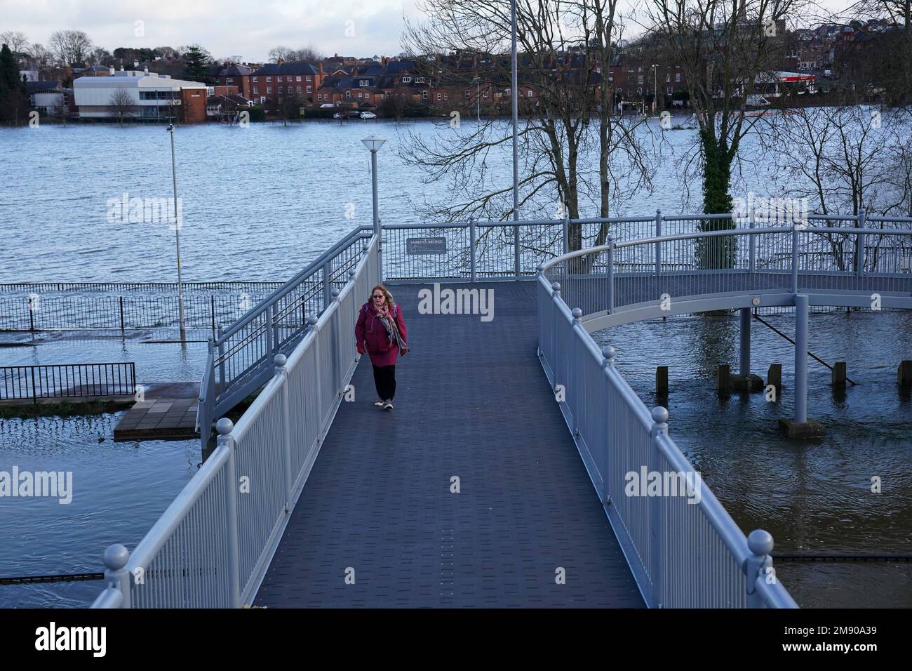 People cross the Sabrina bridge overlooking the flooded Worcester ...