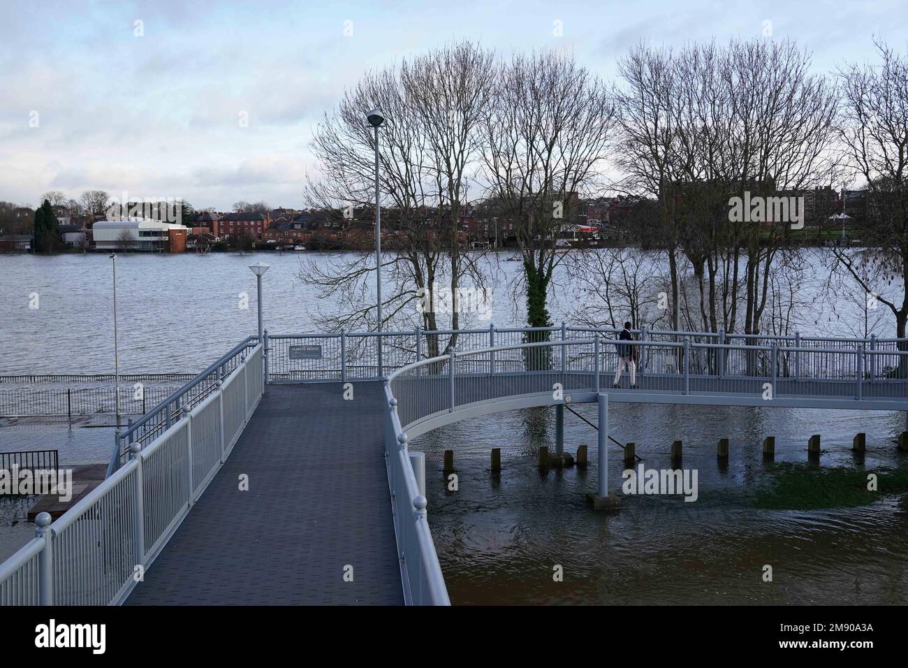 People cross the Sabrina bridge overlooking the flooded Worcester ...