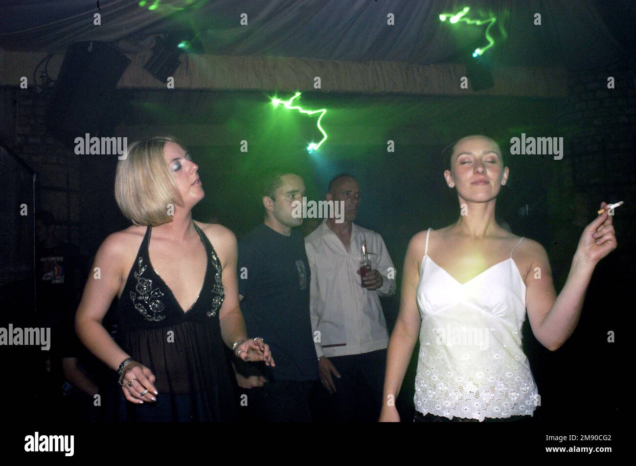 DRUM AND BASS CLUB, DANCERS, CROWD, 2003: Two young women smoking ...