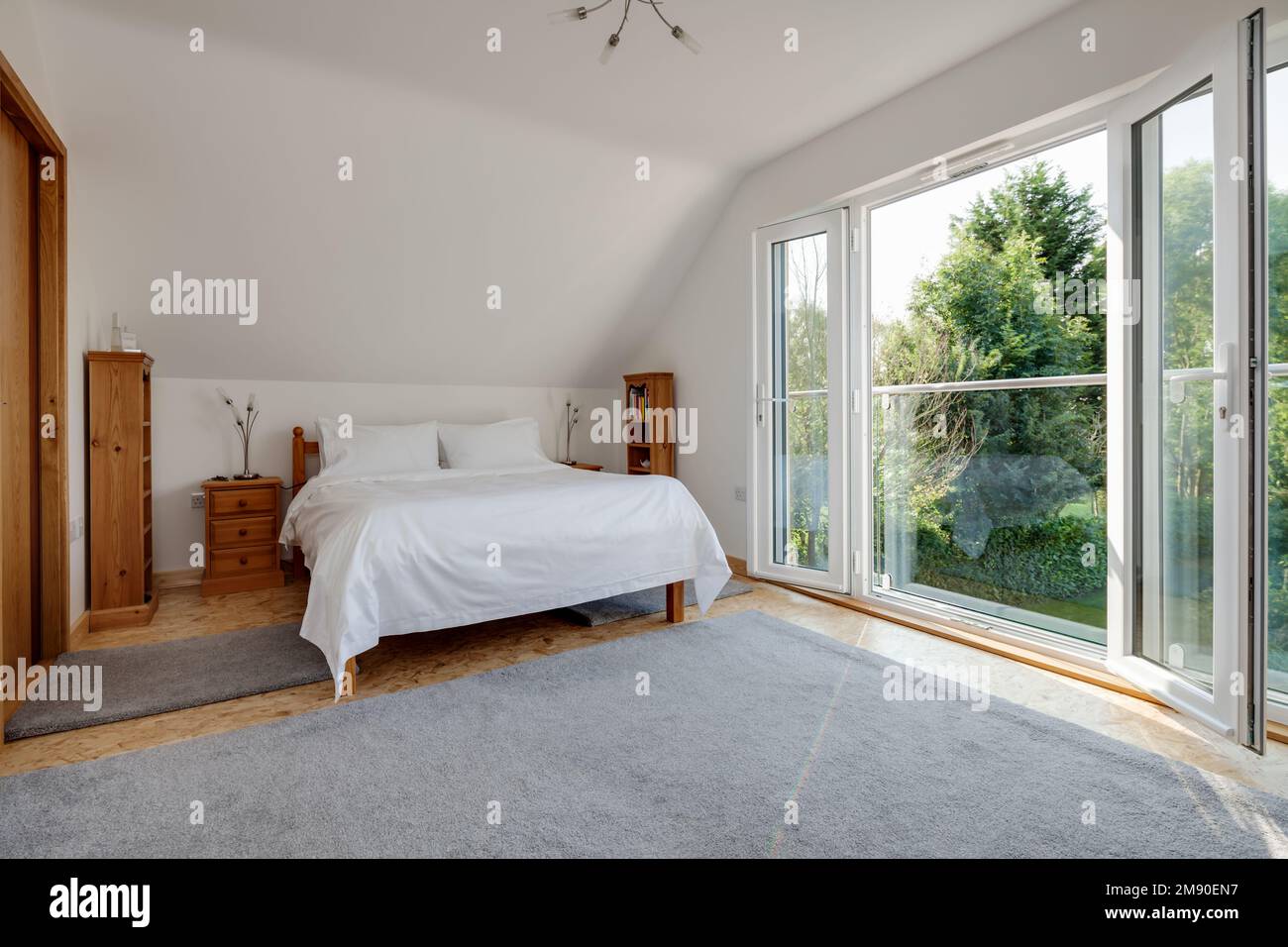 Furnished bright sunlit bedroom with pine furniture and open upvc ...